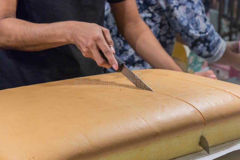 The Man Was Cutting Large Bread with a Knife To Cut the Bread ...