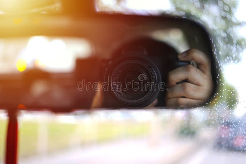 A Man Was Taking a Picture of Himself through the Rear-view Mirror ...