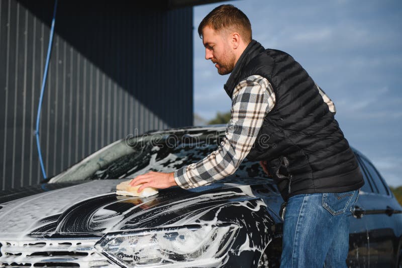 A Man Washes a Car with a Sponge at a Self-service Car Wash Stock Image ...
