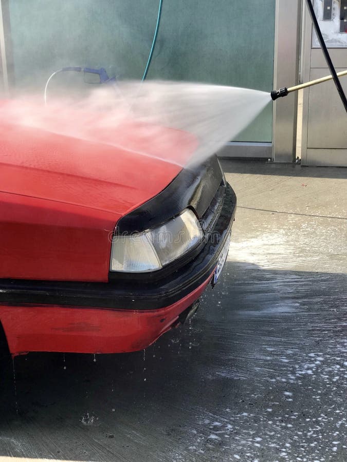 A Man Washes a Red Car at a Car Wash with Detergent Stock Photo - Image ...