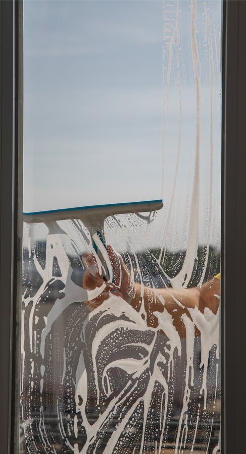 A Man Washes Windows on a Sunny Day Standing on the Balcony Stock Image ...