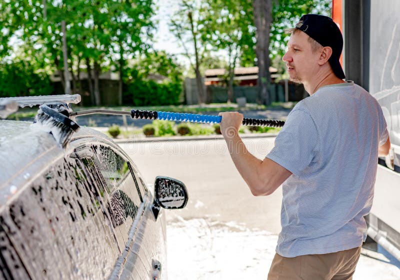 A Man Washing a Car at a Self-service Car Wash Stock Photo - Image of ...