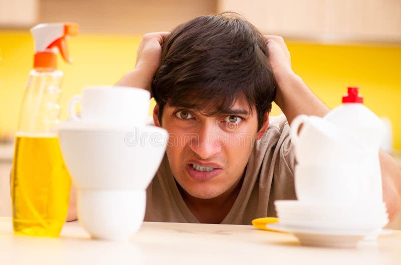 Man washing dishes at home stock image. Image of homework - 181601255