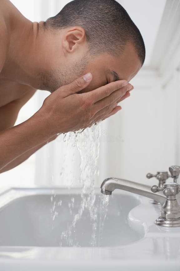 Man Washing Face in Sink stock photo. Image of refreshing - 29656954