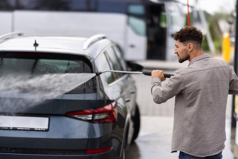 Young Man Washing His Car Under High Pressure Water Outdoors Stock ...
