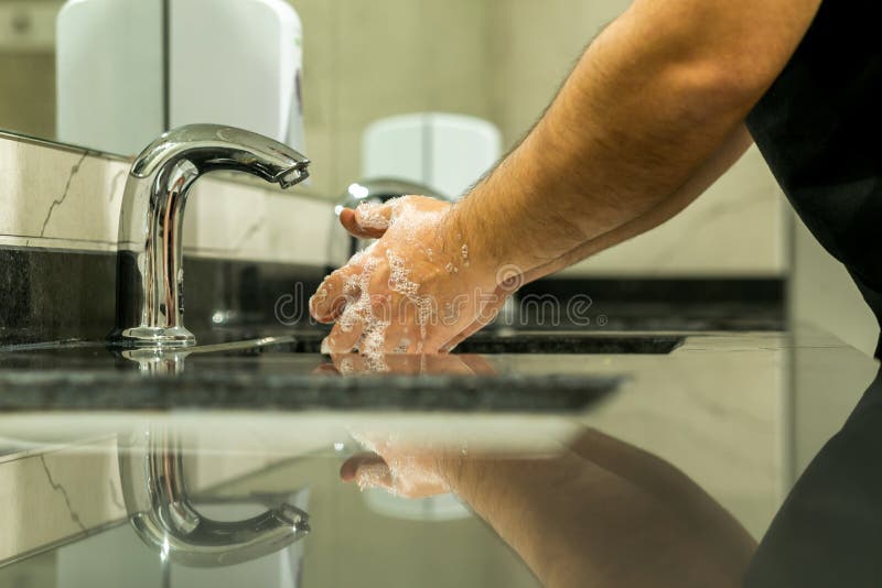 A Man Washing His Hands in a Sink Stock Photo - Image of body, liquid ...