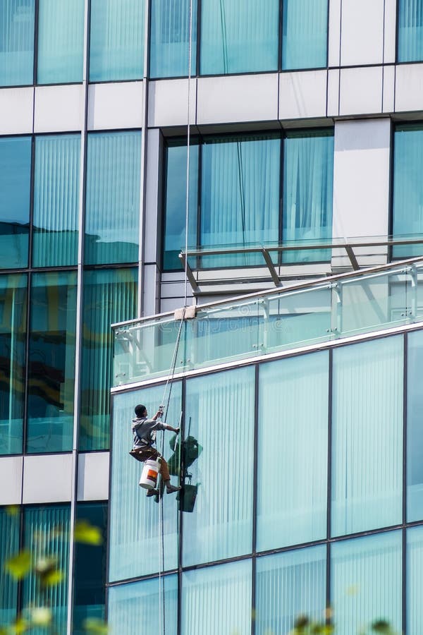 Man Washing Windows on a Glass Skyscraper Editorial Stock Image - Image ...