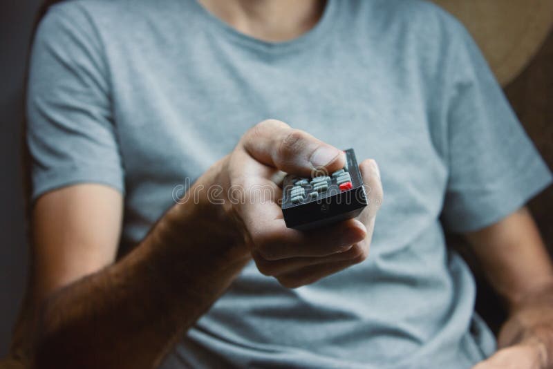 The Man Watches TV and Holds a Remote Control in Her Hands Stock Image ...