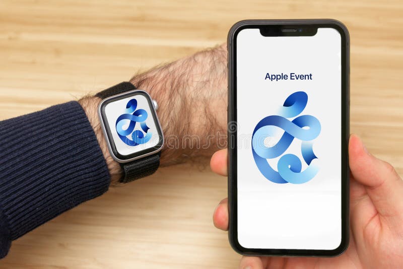 Man is Watching Apple Event 2020 Using IPhone and Watch. Apple Logo on ...