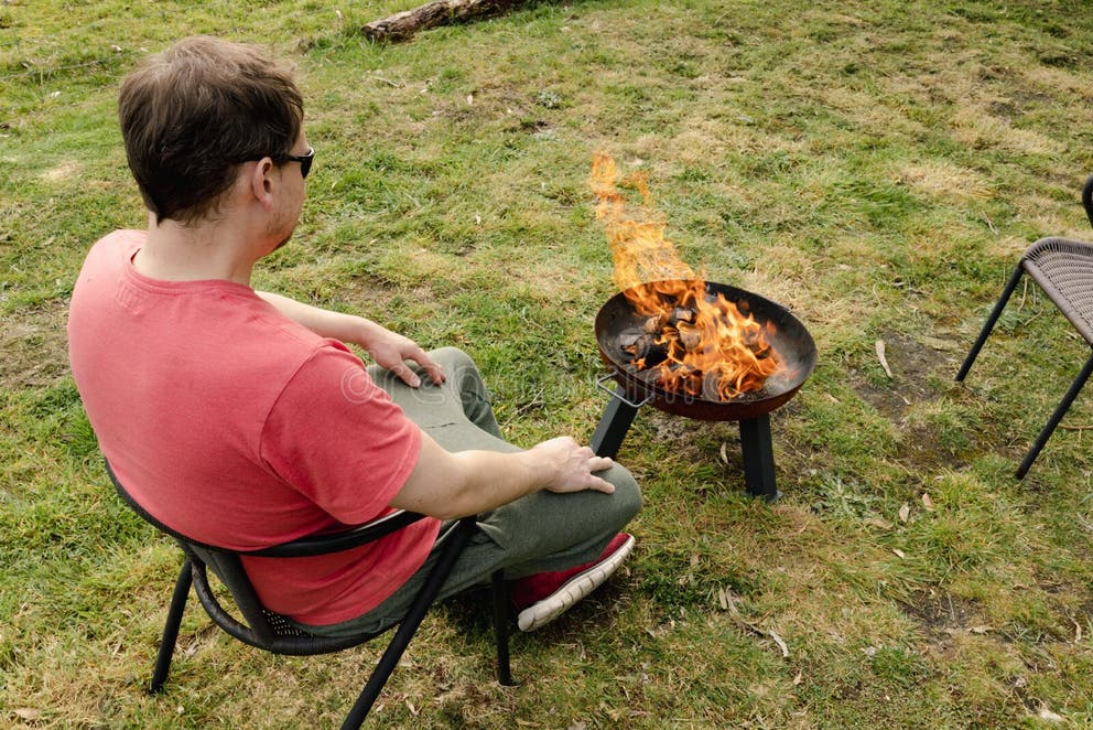A man watching a fire stock photo. Image of winter, male - 255142646