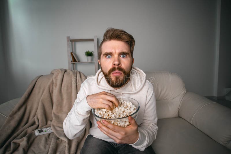 Man Watching Movies Sitting on a Couch at Home. Stock Photo - Image of ...