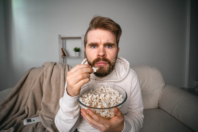 Man Watching Movies Sitting on a Couch at Home. Stock Photo - Image of ...