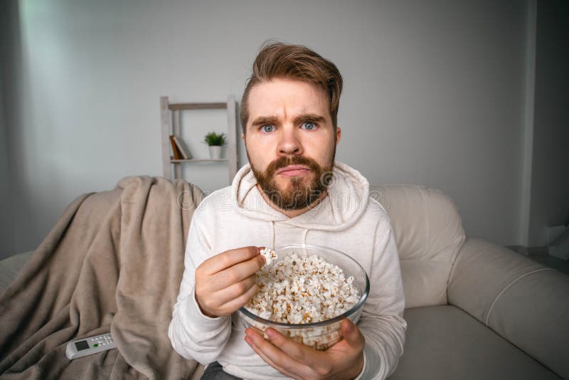 Man Watching Movies Sitting on a Couch at Home. Stock Photo - Image of ...