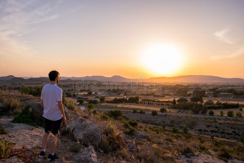 Man Watching the Sunset in a Mountain Stock Photo - Image of ...