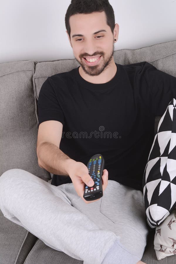 Man watching tv on couch. stock photo. Image of livingroom - 100595012