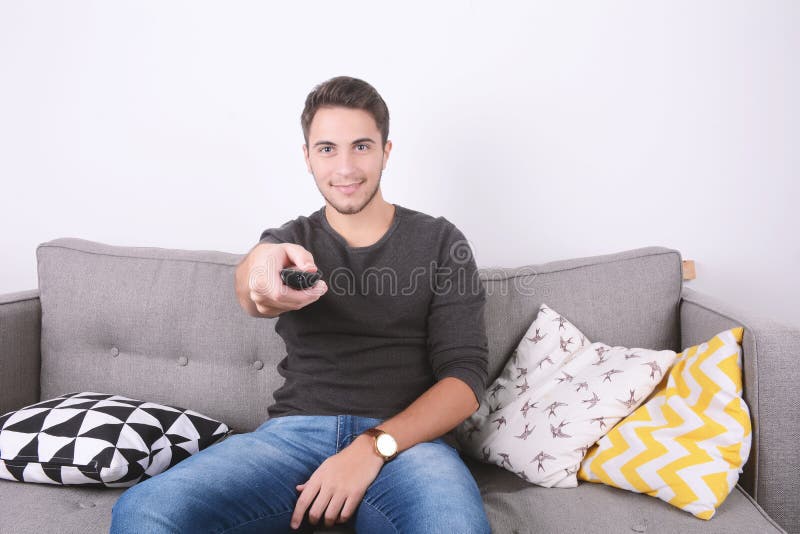 Man watching tv on couch. stock image. Image of looking - 86561401