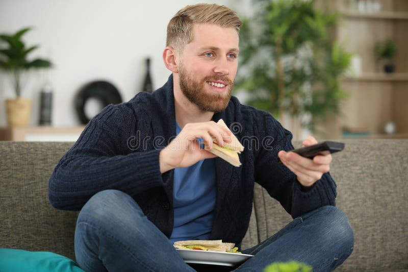 Man Watching Tv while Eating Lunch on Sofa Stock Image - Image of ...