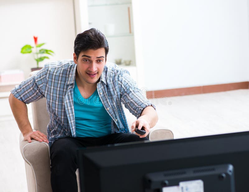 Man watching tv at home stock image. Image of channel - 163776667