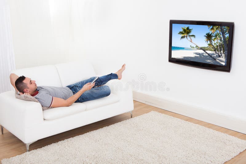 Man watching tv at home stock image. Image of beach, relaxation - 46844973