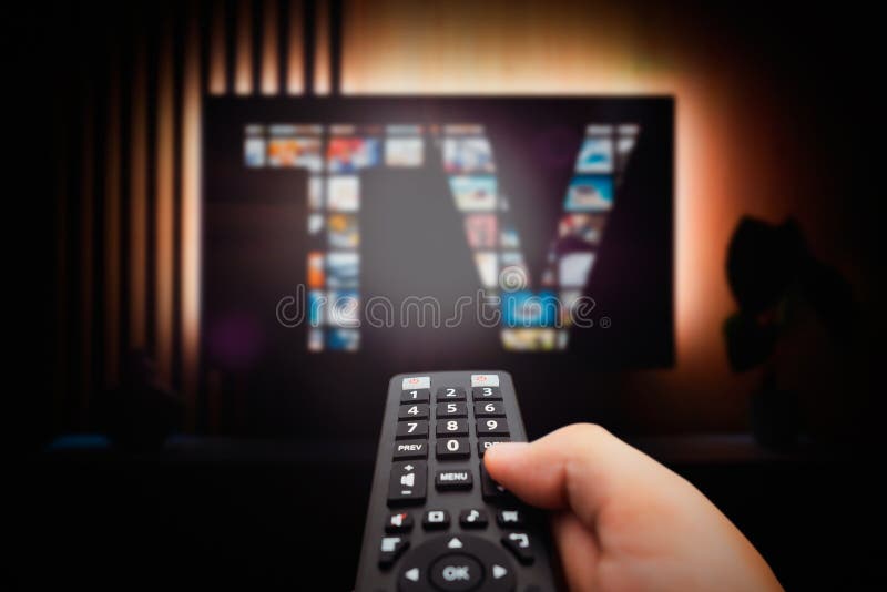 Man Watching TV with Remote Control in Hand Stock Photo - Image of ...