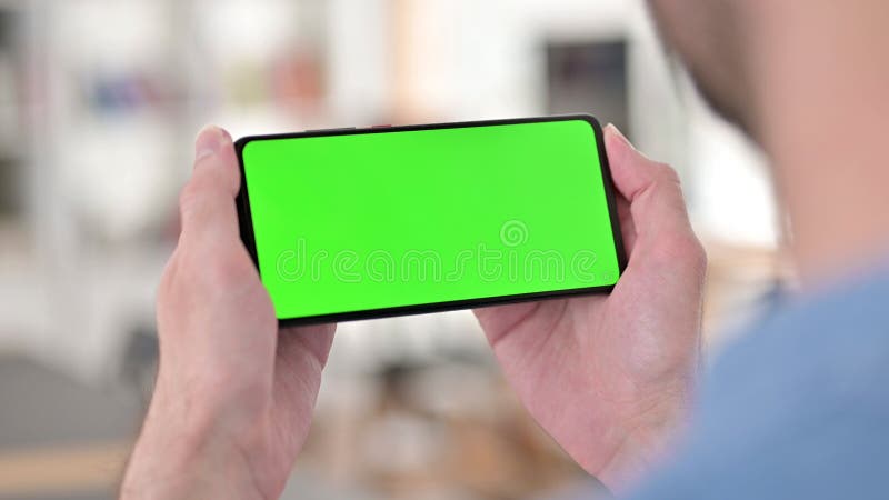 Man Watching Video on Green Smartphone Screen, Chroma Key Stock Image ...