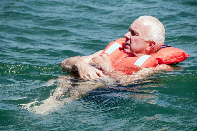 Man Water Life Jacket Huddle Position Stock Photos - Free & Royalty ...