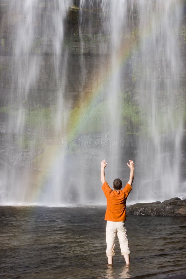 Man and Waterfall with Rainbow Stock Photo - Image of power, rapid: 4374118