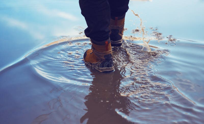A Man in Waterproof Shoes Crosses the Pond Stock Photo - Image of lake ...