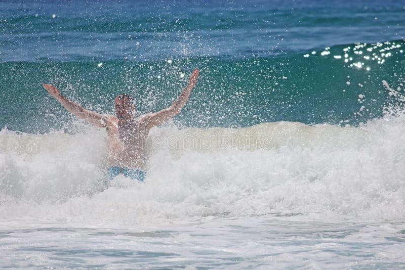 Man in the waves stock photo. Image of breaking, beach - 20901624