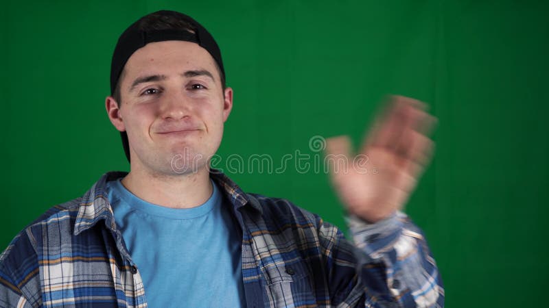 A Man Waves His Hand at the Camera while Standing on the Background of ...