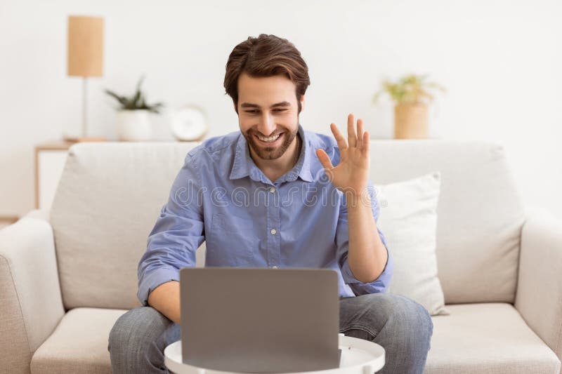 Man Waving To Laptop Making Video Call Sitting at Home Stock Image ...