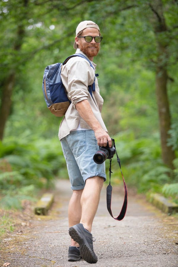 Man Wearing Backpack Walking in Forest Holding Dslr Camera Stock Image ...