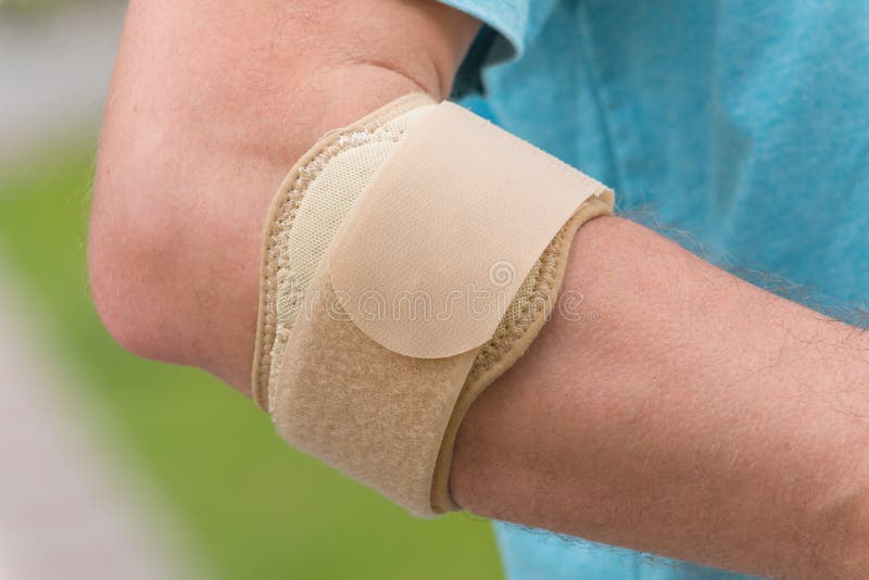 Man wearing elbow brace stock photo. Image of discomfort - 72409366