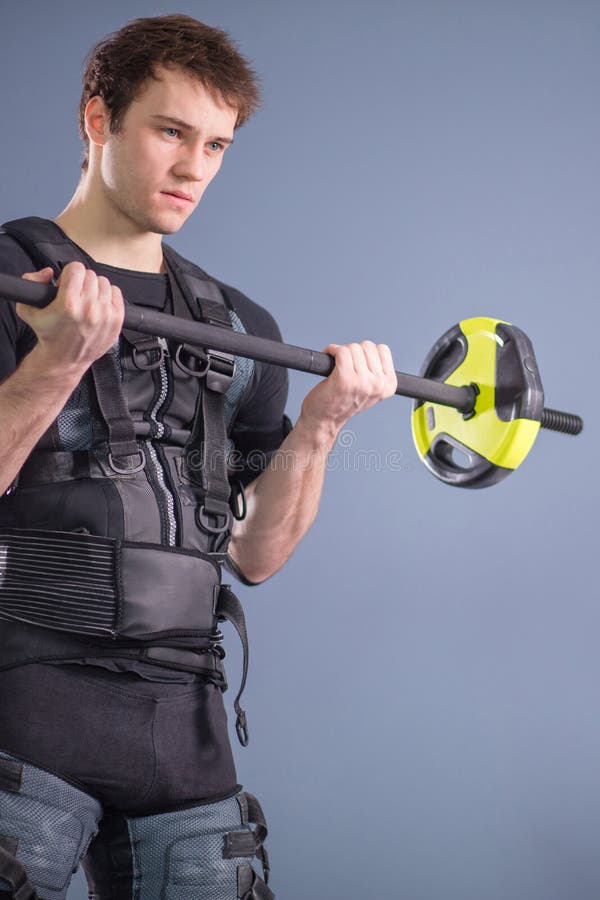Man Working Out EMS Training with Barbell Closeup, Power Pose Stock ...