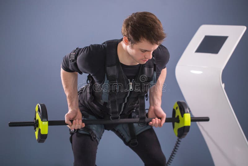 Man Working Out EMS Training with Barbell Closeup, Power Pose Stock ...