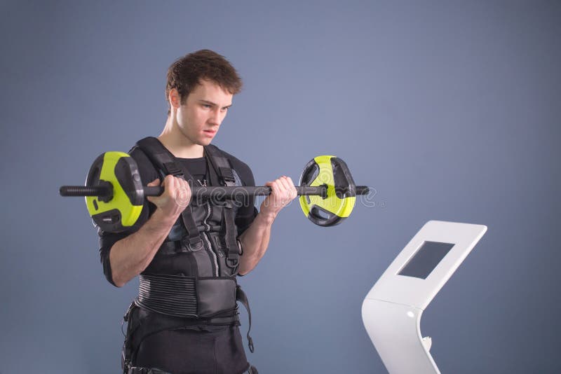 Man Working Out EMS Training with Barbell Closeup, Power Pose Stock ...