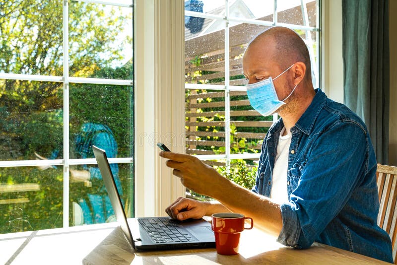 Man Wearing a Face Mask Checking His Phone. Stock Image - Image of ...