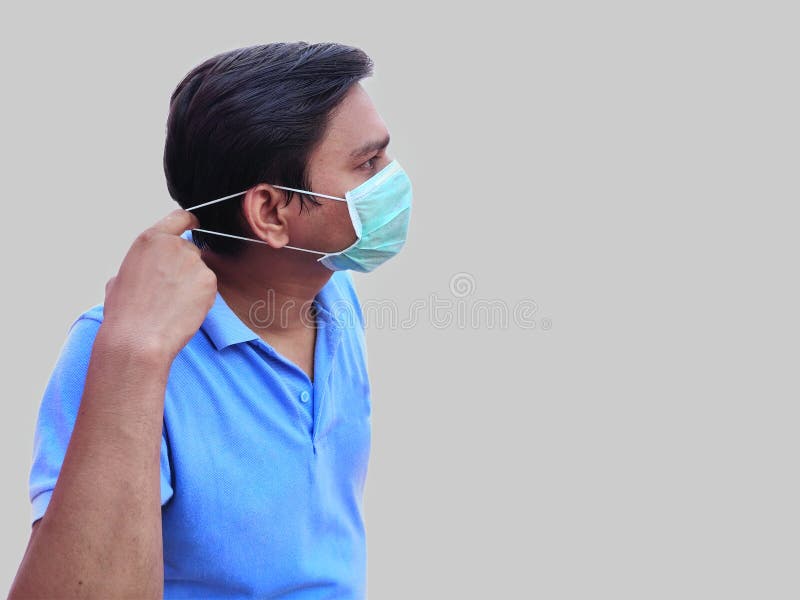 Man Wearing Face Mask Pulling Mark Strings To Place it Over Ears Stock ...
