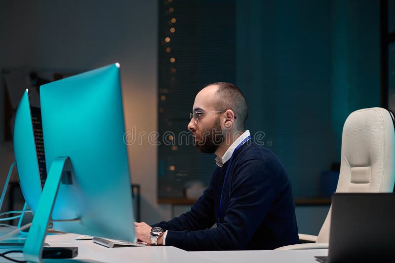 Man Wearing Glasses Using Computer in Blue Light Stock Photo - Image of ...