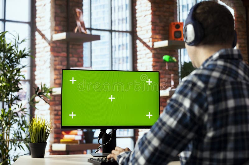 Man Wearing Headphones Engaging in Online Training Session on Green ...