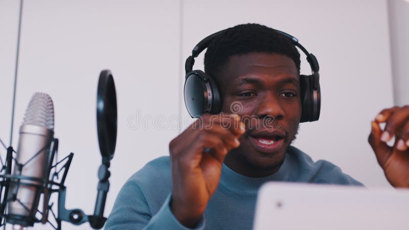 Man Wearing Headphones Taking an Online Class Using a Laptop and ...