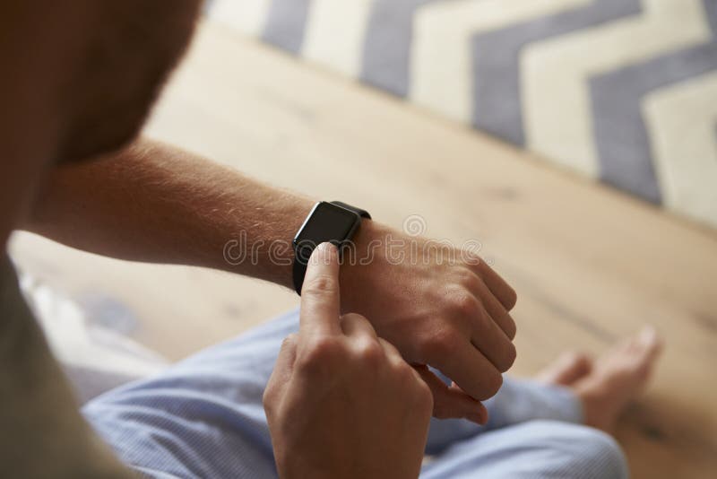 Man Wearing Pajamas Checking Smart Watch in Bedroom Stock Photo - Image ...