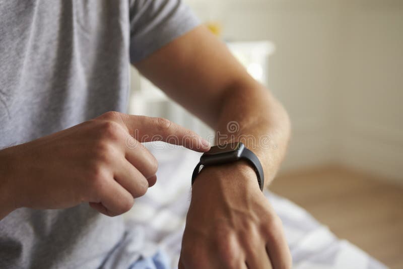Man Wearing Pajamas Checking Smart Watch in Bedroom Stock Photo - Image ...