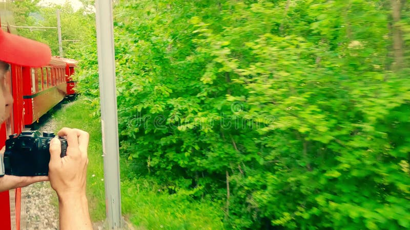 Photographer Wearing Red Cap Takes Pictures of a Retro Red Train in ...