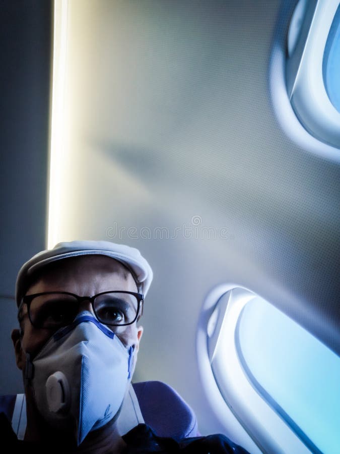Man Wearing Respirator Protective Mask on His Face Inside Plane Stock ...