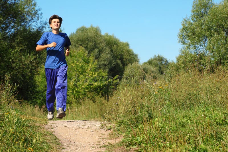 Man Wearing Sporty Clothes Is Running Along Path Stock Photo - Image of ...