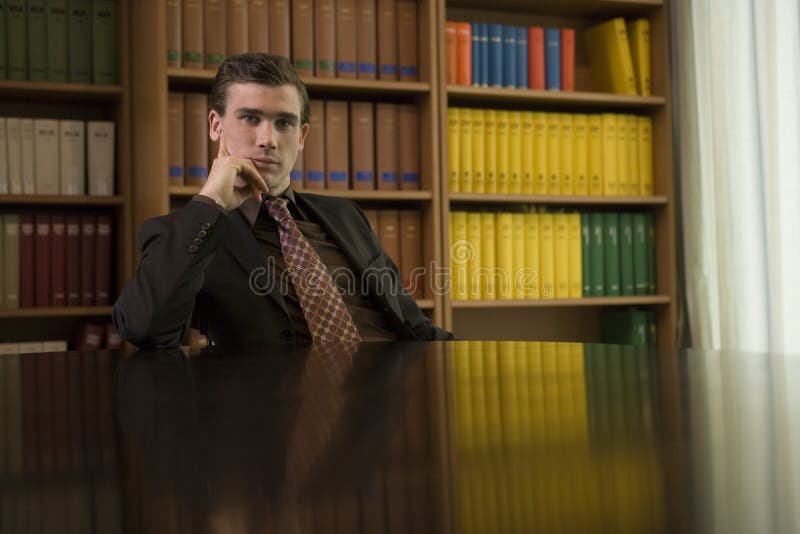 Serious Man in Suit at Library Desk Stock Image - Image of bookcase ...