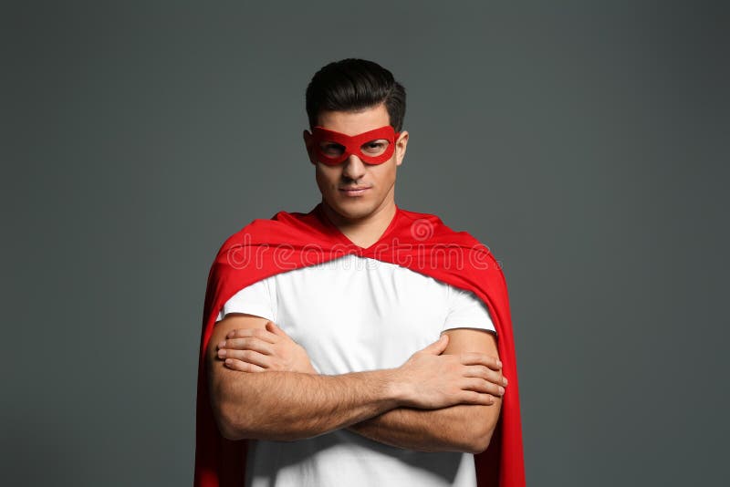 Man Wearing Superhero Cape and Mask on Grey Background Stock Image ...