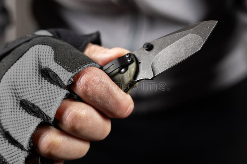 The Man Wearing Tactical Gloves Using Folding Knife Stock Photo - Image ...