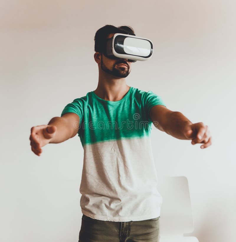 Man Wearing Virtual Reality Goggles. Stock Image - Image of shirt, gray ...